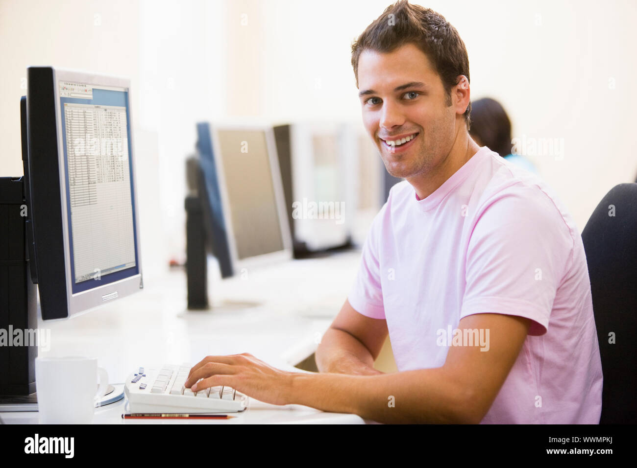 Man in computer room smiling Stock Photo - Alamy