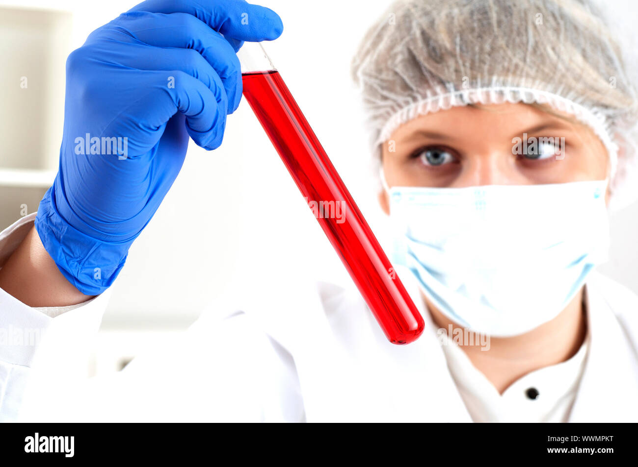 female chemist mixing liquids in test tubes, working in lab Stock Photo ...