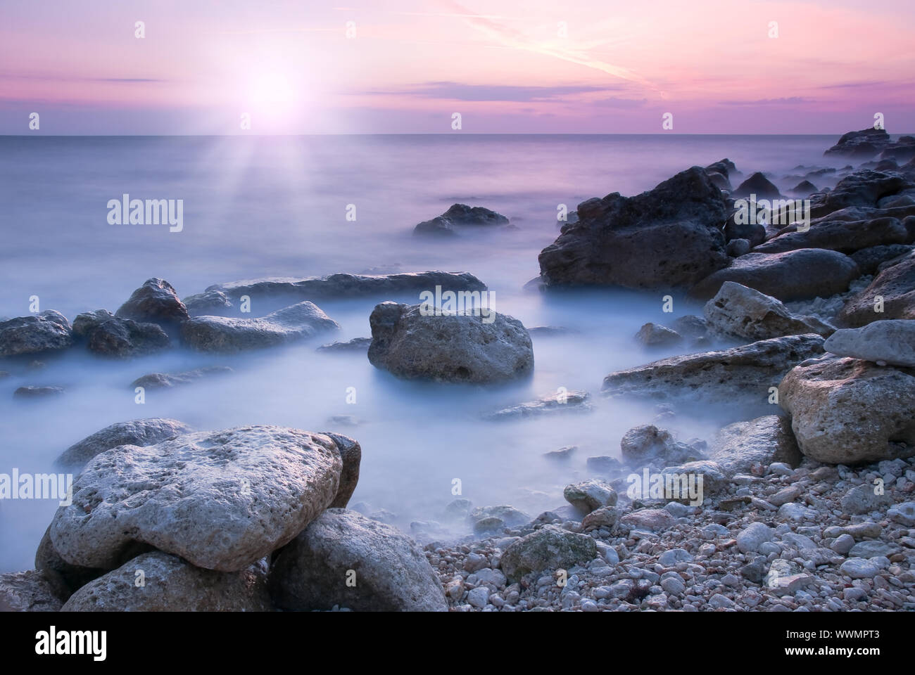 Beautiful rocky sea beach at the sunset Stock Photo - Alamy