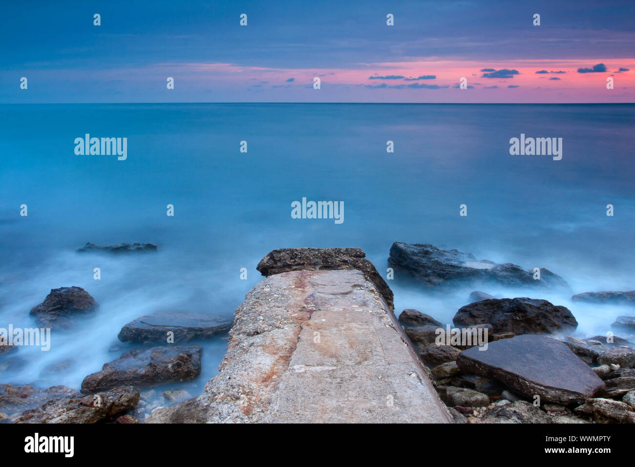 Beautiful rocky sea beach at the sunset Stock Photo - Alamy