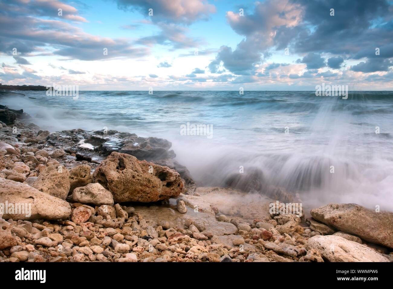 Beautiful rocky sea beach at the sunset Stock Photo - Alamy