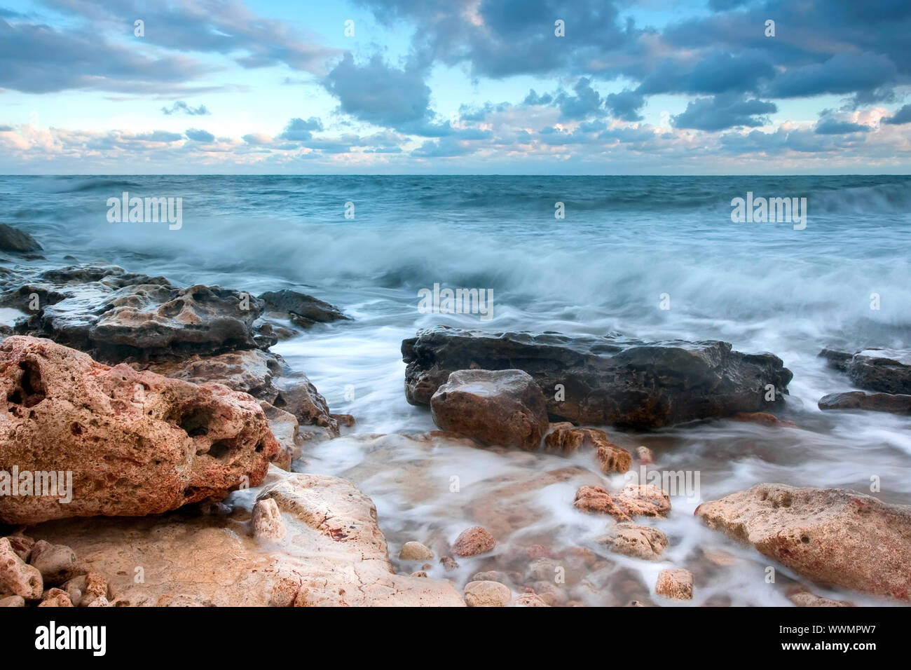 Beautiful rocky sea beach at the sunset Stock Photo - Alamy