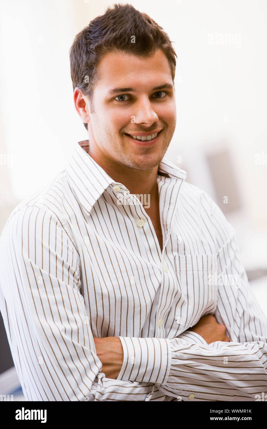 Man standing in computer room smiling Stock Photo - Alamy