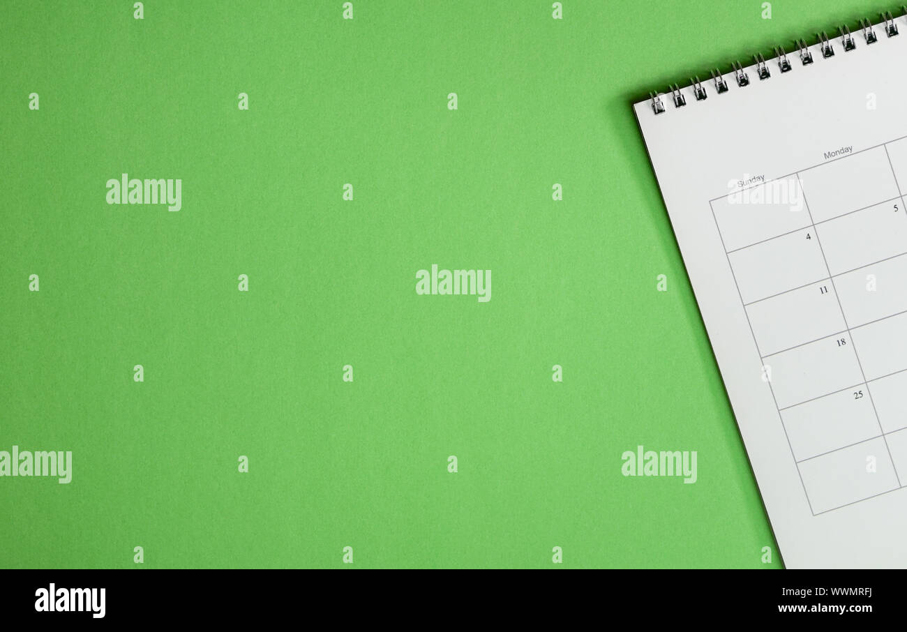 Calendar or planner on green background with copy space. Business ...