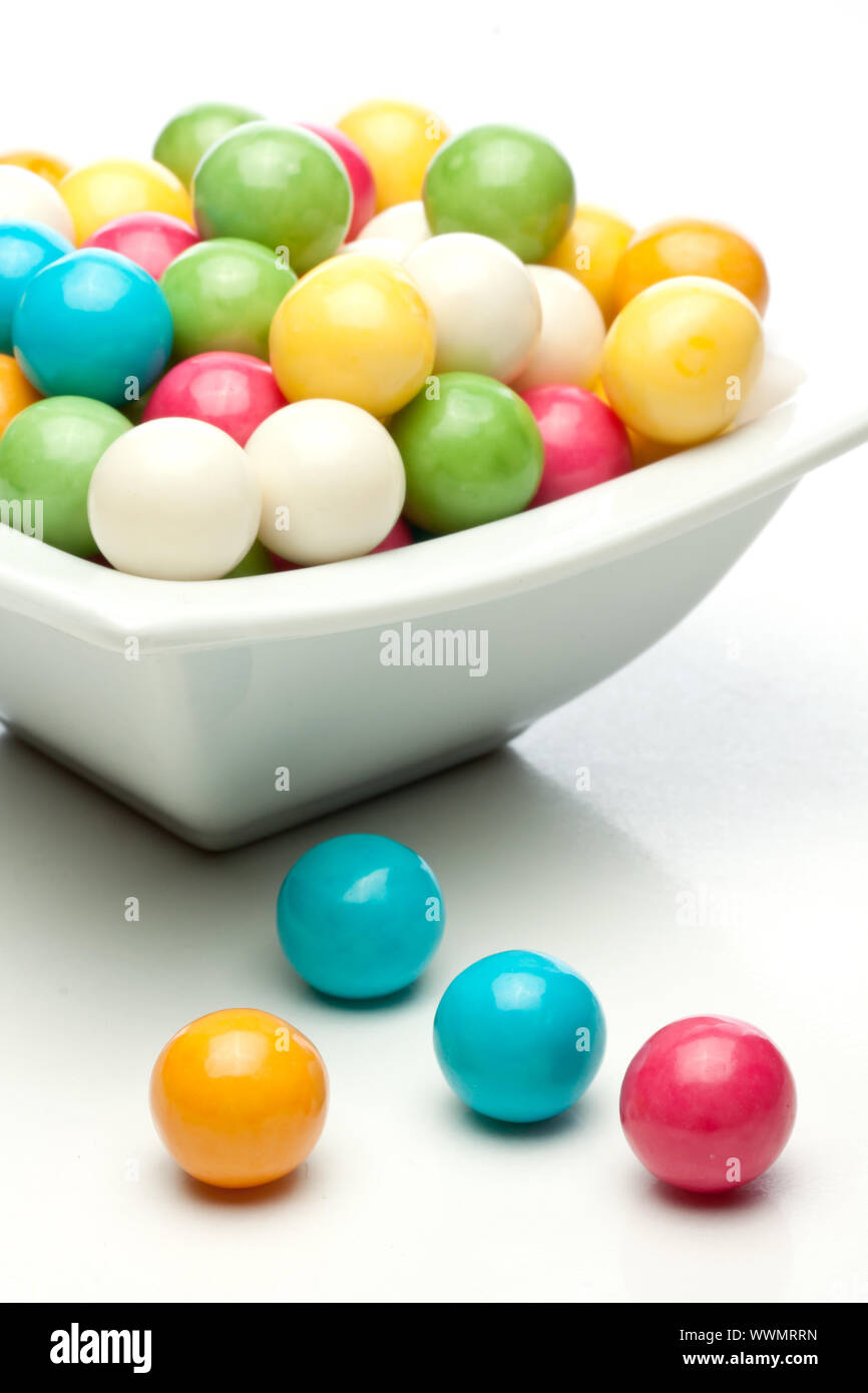 many colored gumballs on a white background Stock Photo - Alamy