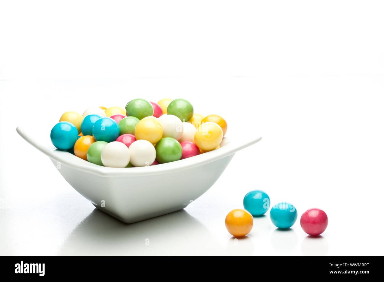 many colored gumballs on a white background Stock Photo - Alamy