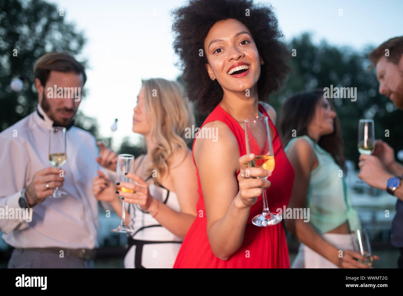 Group of friends at party dancing and smiling together Stock Photo - Alamy