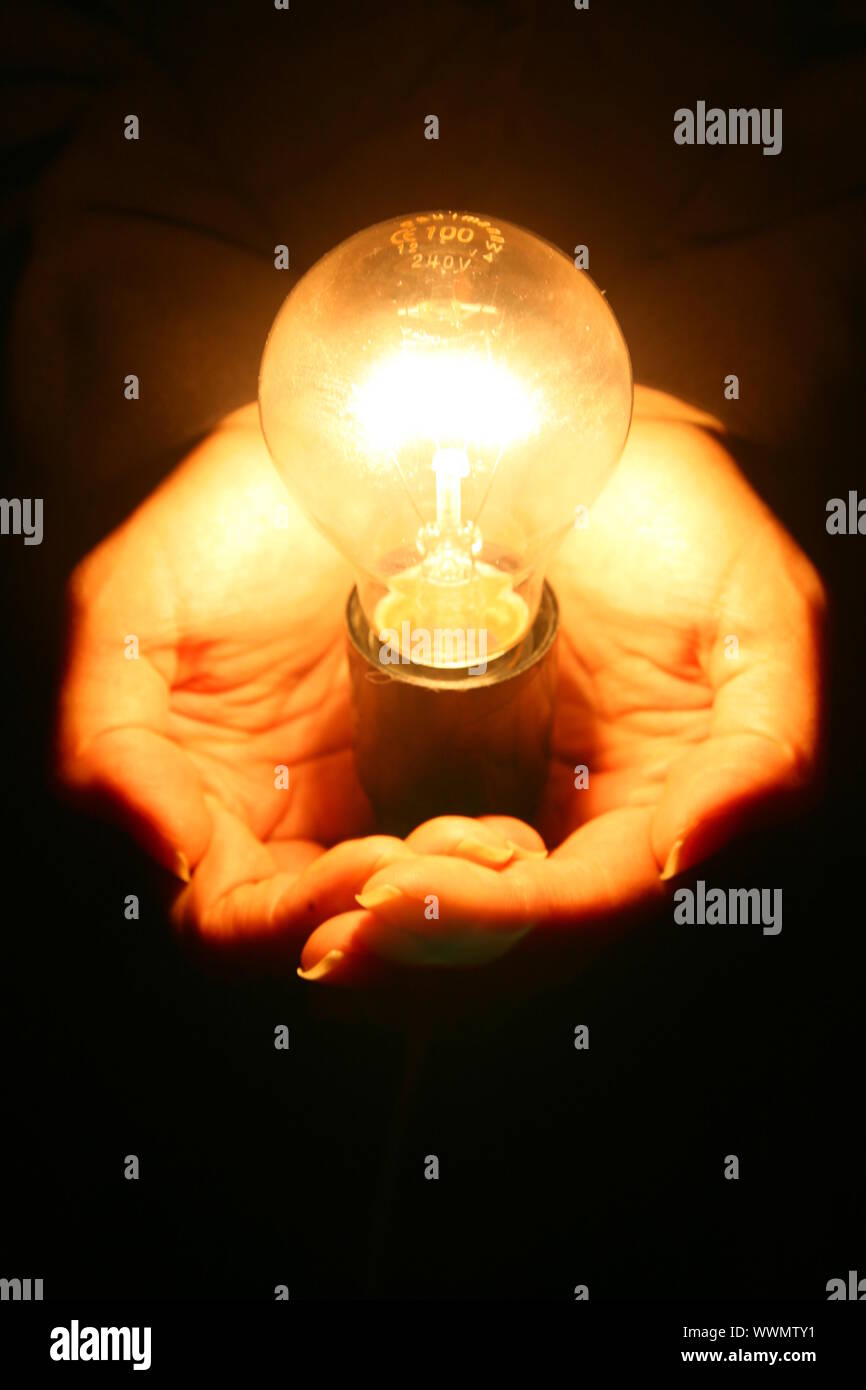 lamp in hand idea concept Stock Photo - Alamy