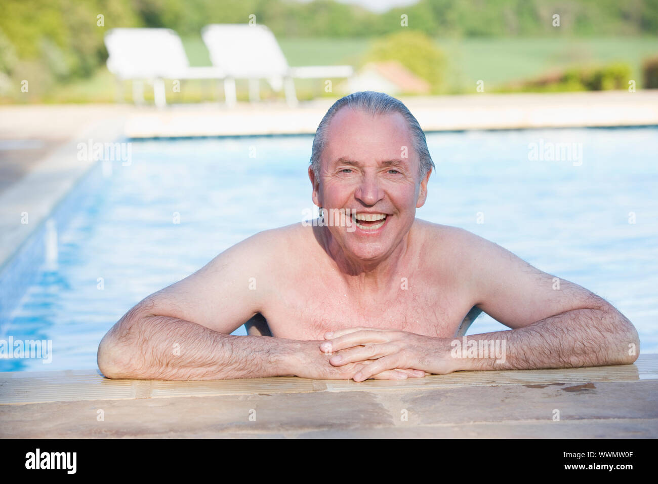 Man in outdoor pool smiling Stock Photo - Alamy