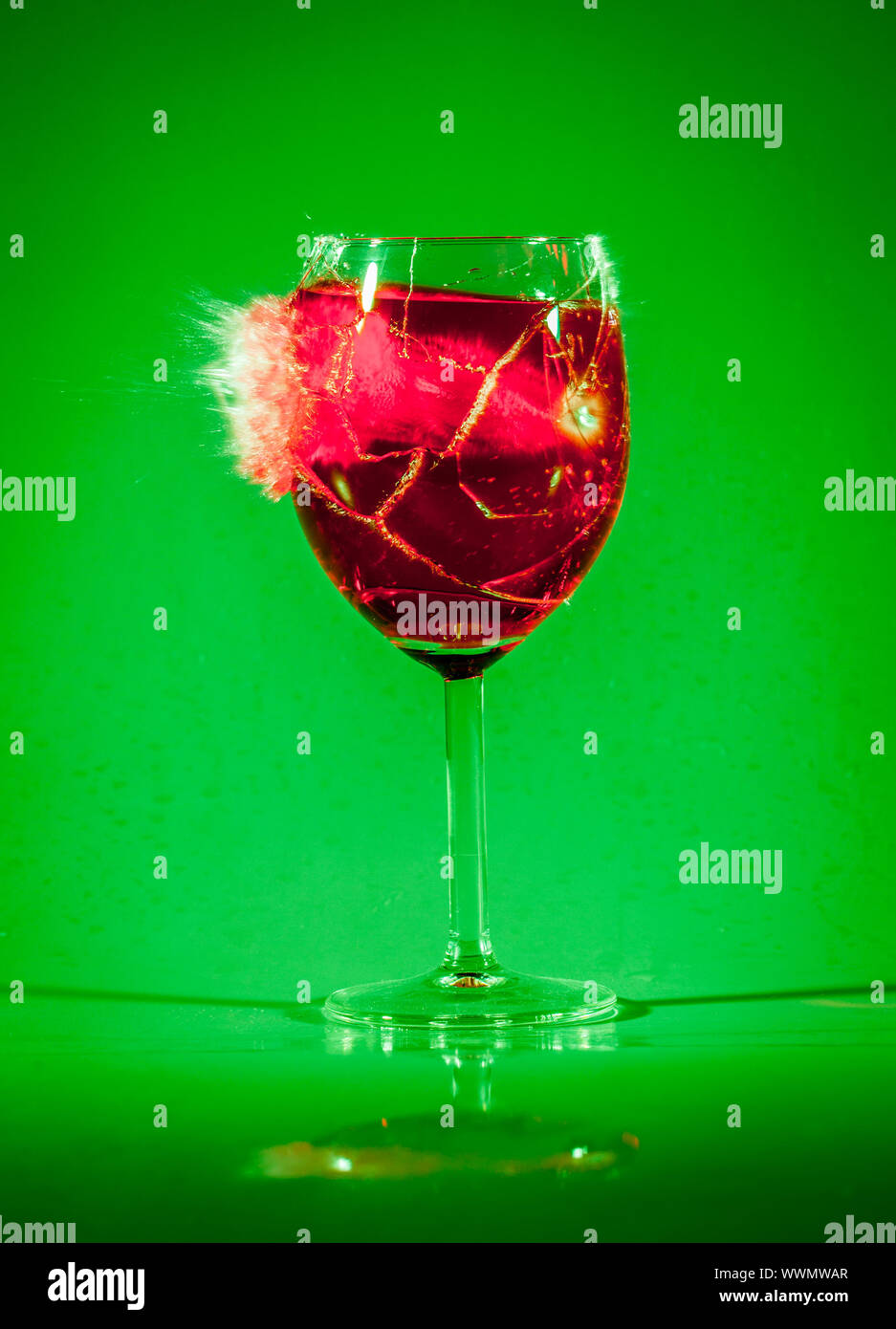 Glass with drink by bullet with many splashes around Stock Photo - Alamy
