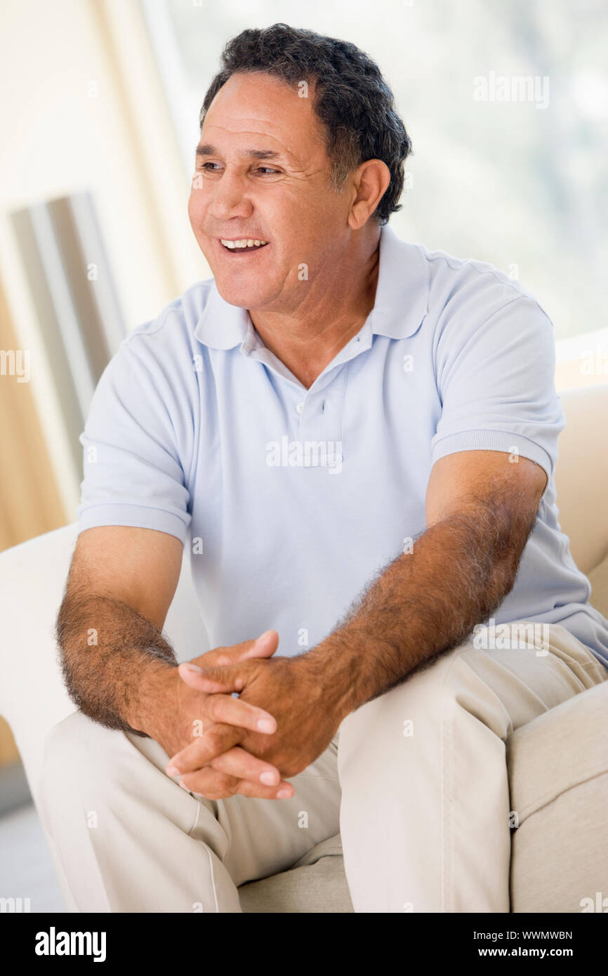 Man in living room smiling Stock Photo - Alamy