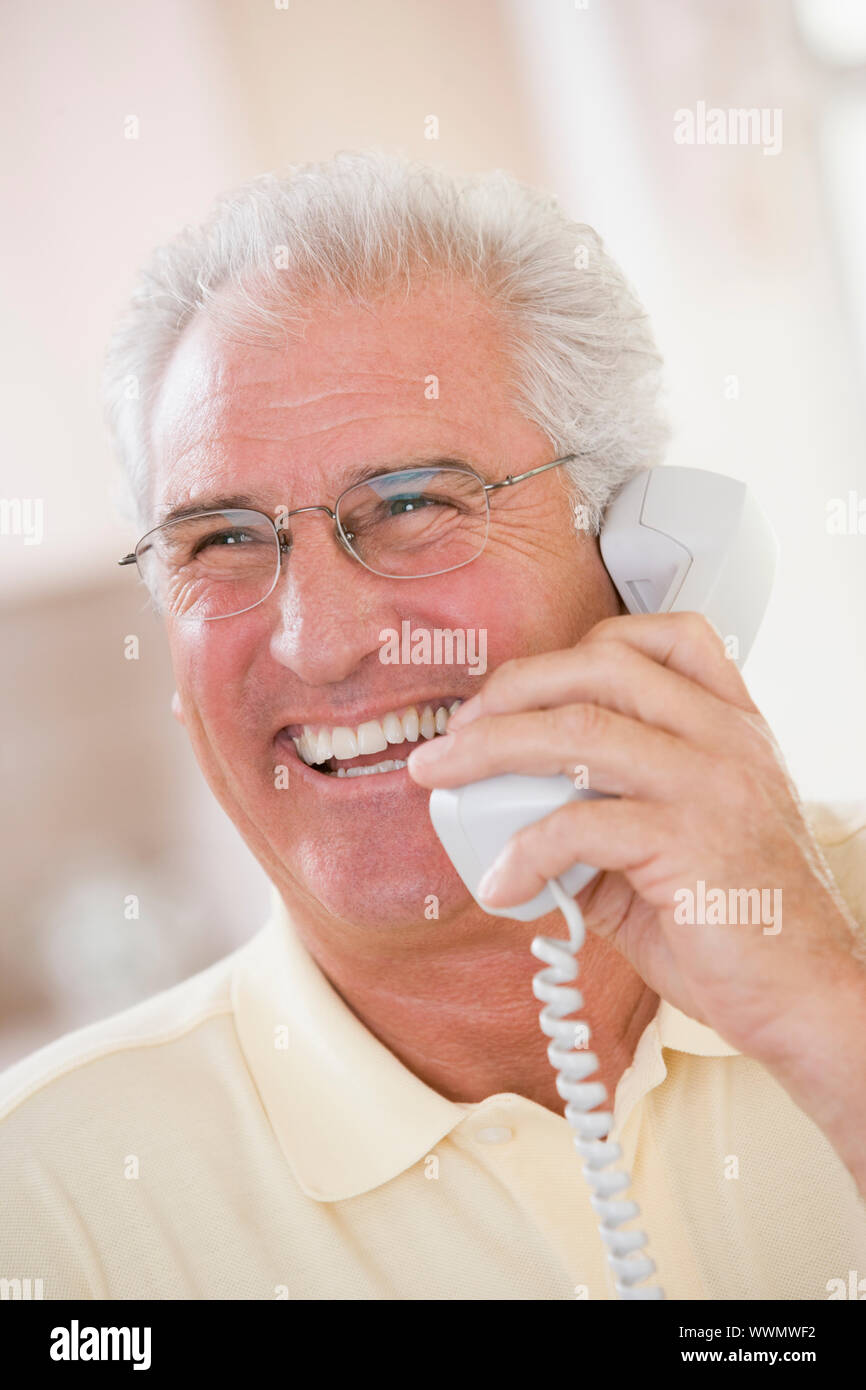 Man using telephone and smiling Stock Photo - Alamy