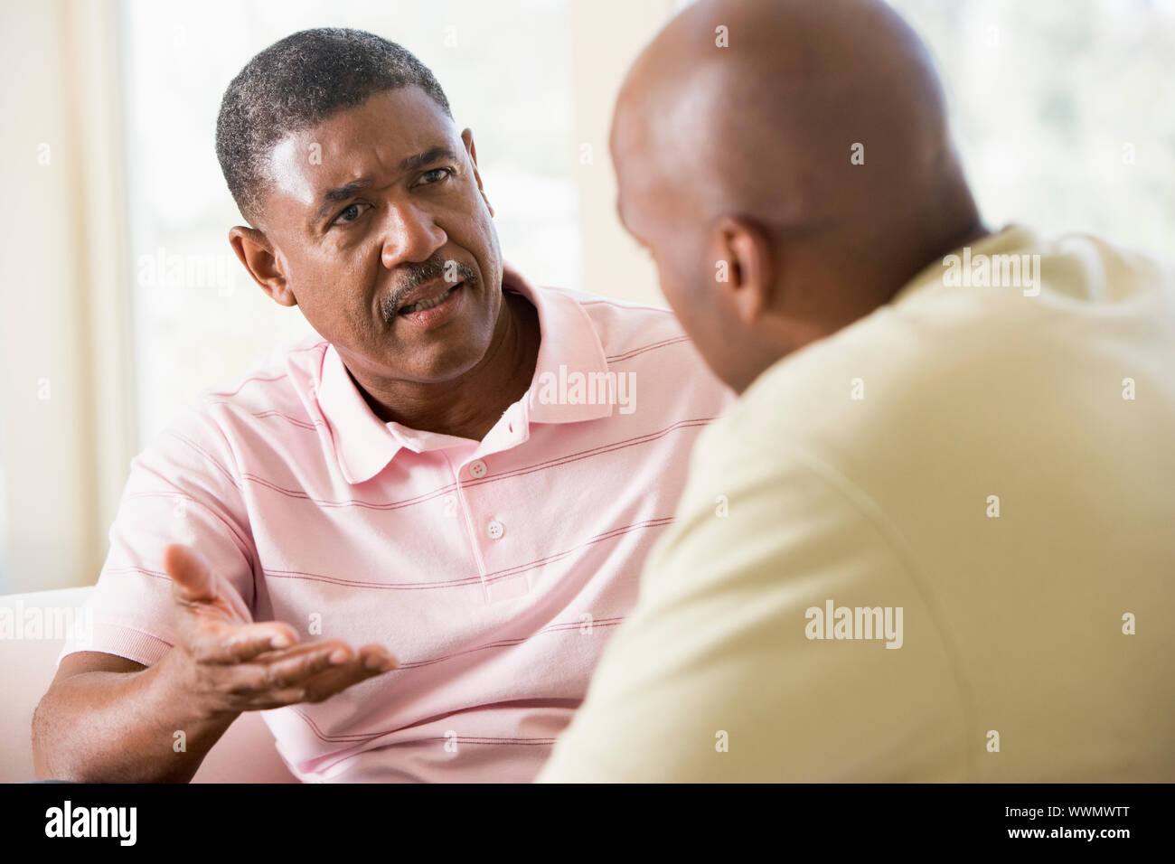 Two men seated talking hi-res stock photography and images - Alamy