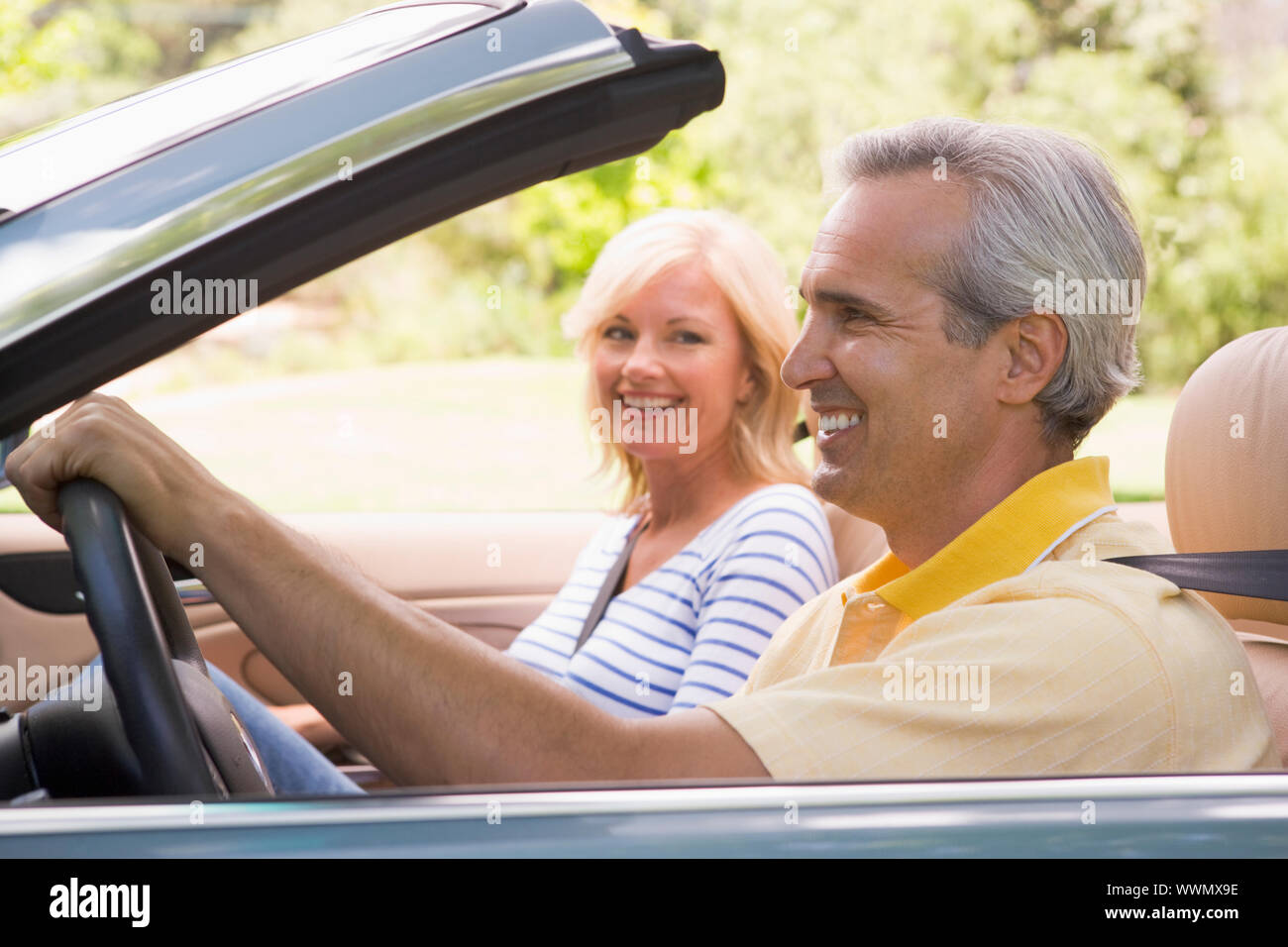 Couple in convertible car smiling Stock Photo - Alamy