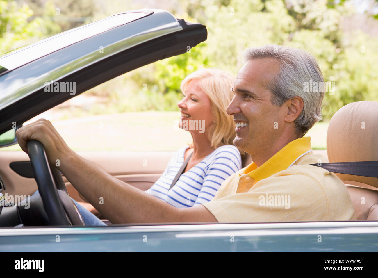 Couple in convertible car smiling Stock Photo - Alamy