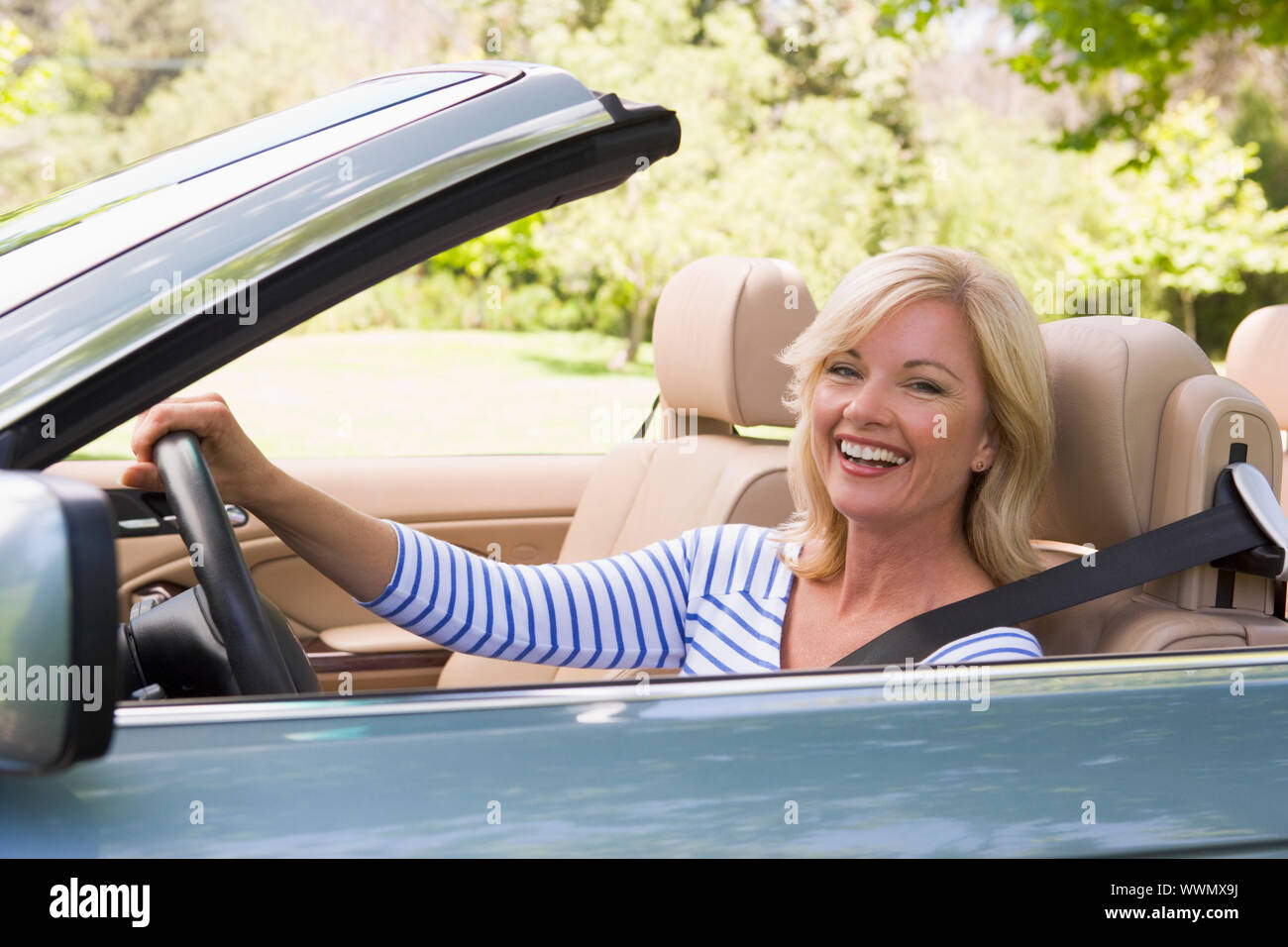 Woman in convertible car smiling Stock Photo - Alamy