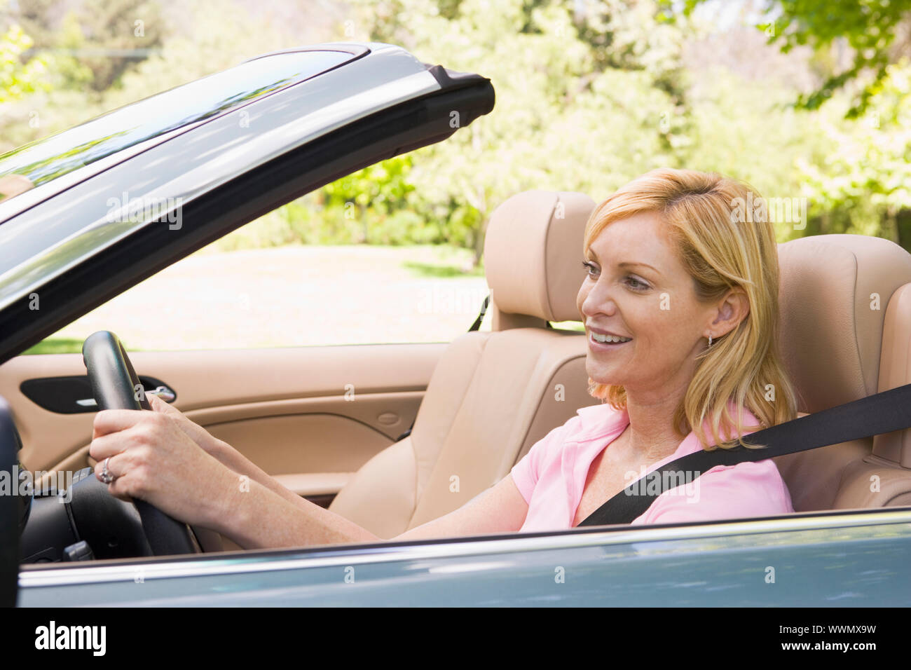 Woman in convertible car smiling Stock Photo - Alamy