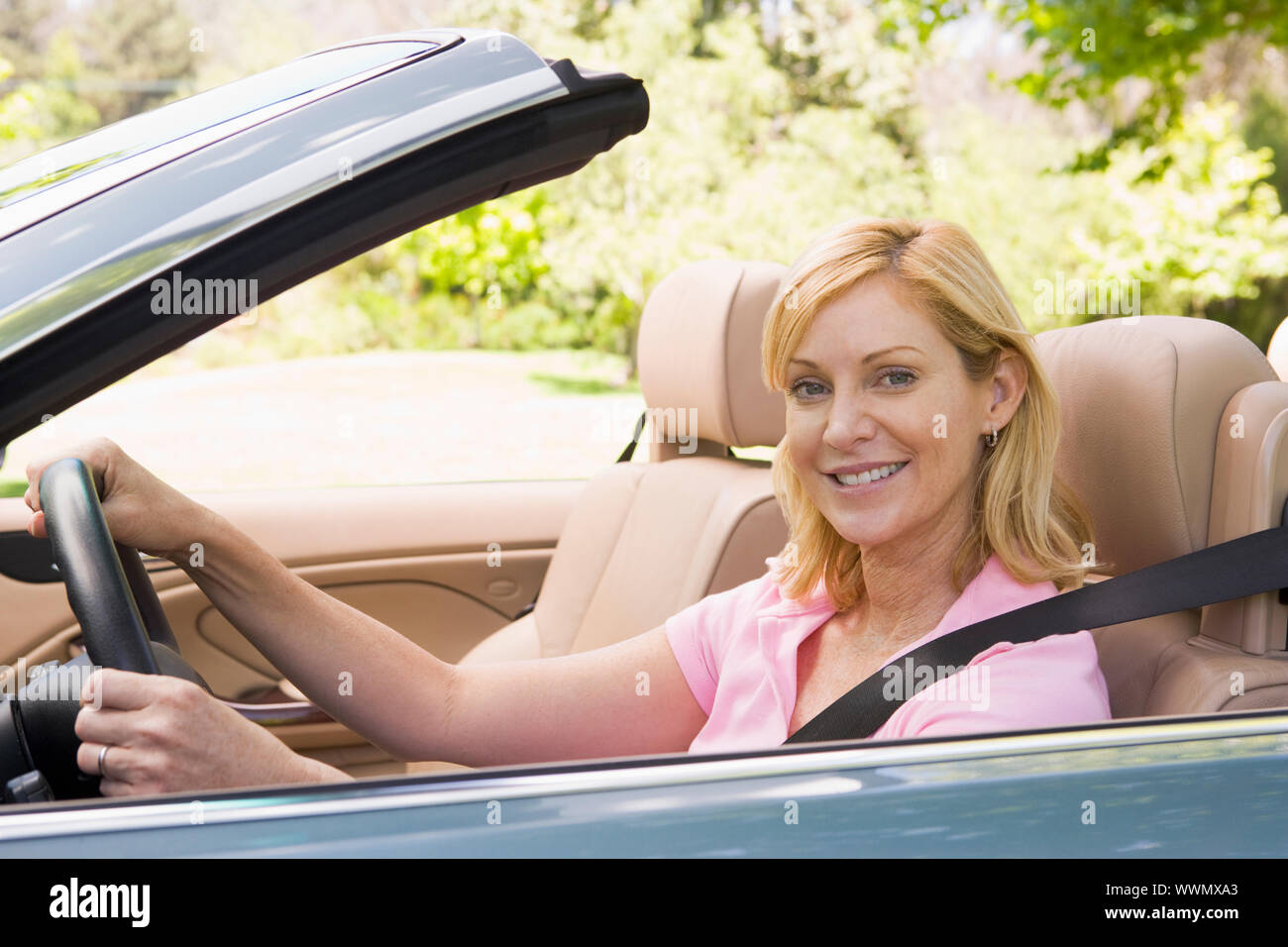 Woman in convertible car smiling Stock Photo - Alamy