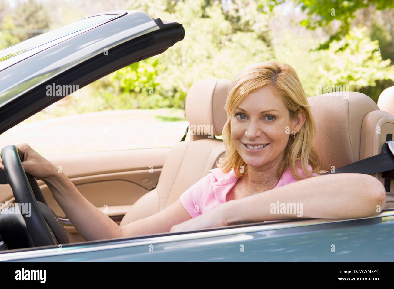 Woman in convertible car smiling Stock Photo - Alamy