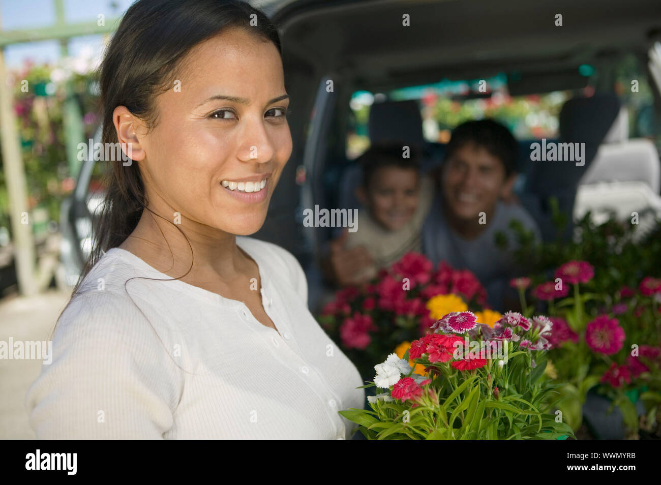 Woman and Family Loading Plants Stock Photo - Alamy