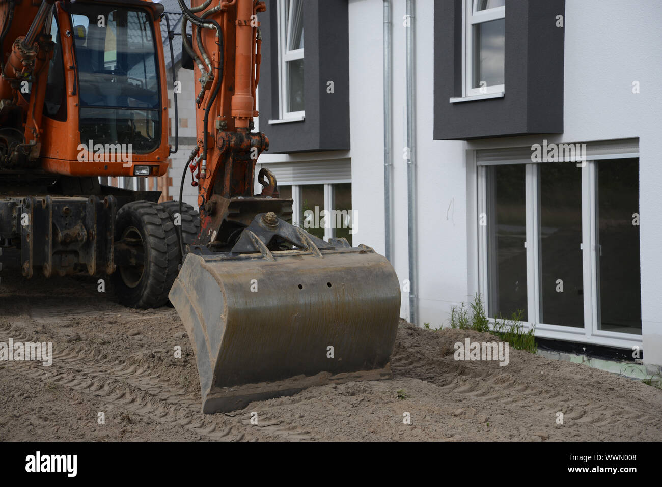 Excavator at a new building Stock Photo - Alamy