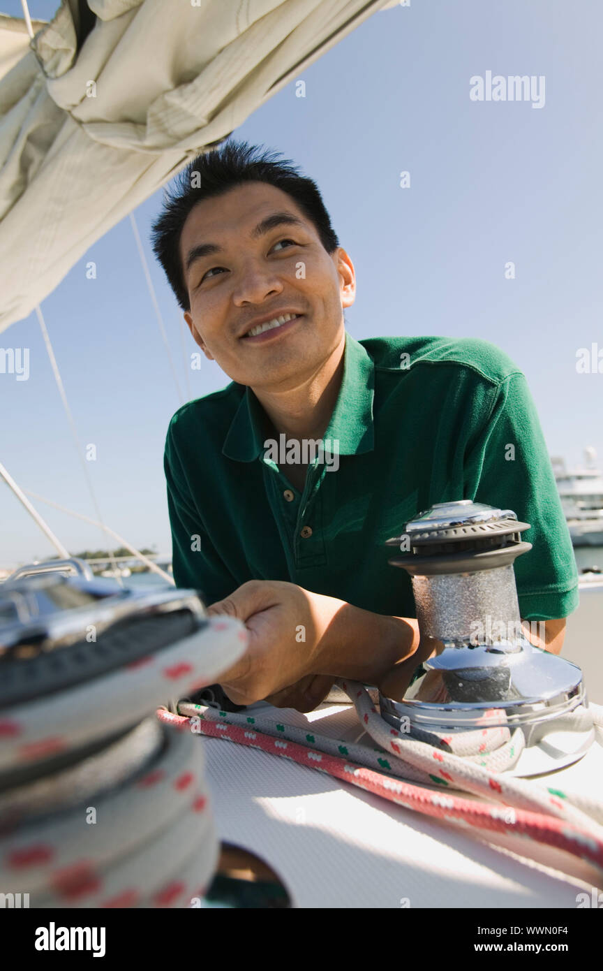 Man adjusting sail hi-res stock photography and images - Alamy