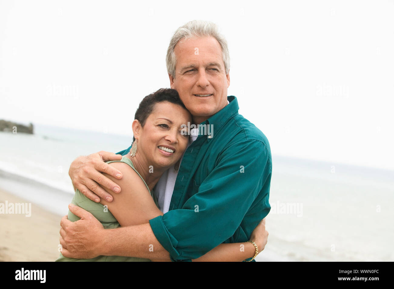 Couple Hugging on Beach Stock Photo - Alamy