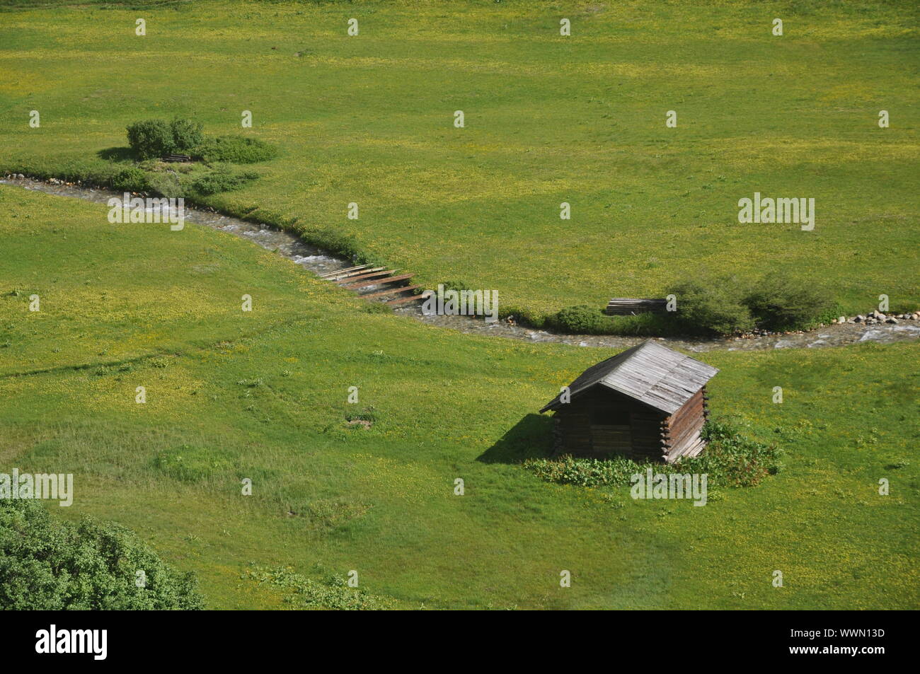 Alpine hut by a stream Stock Photo - Alamy