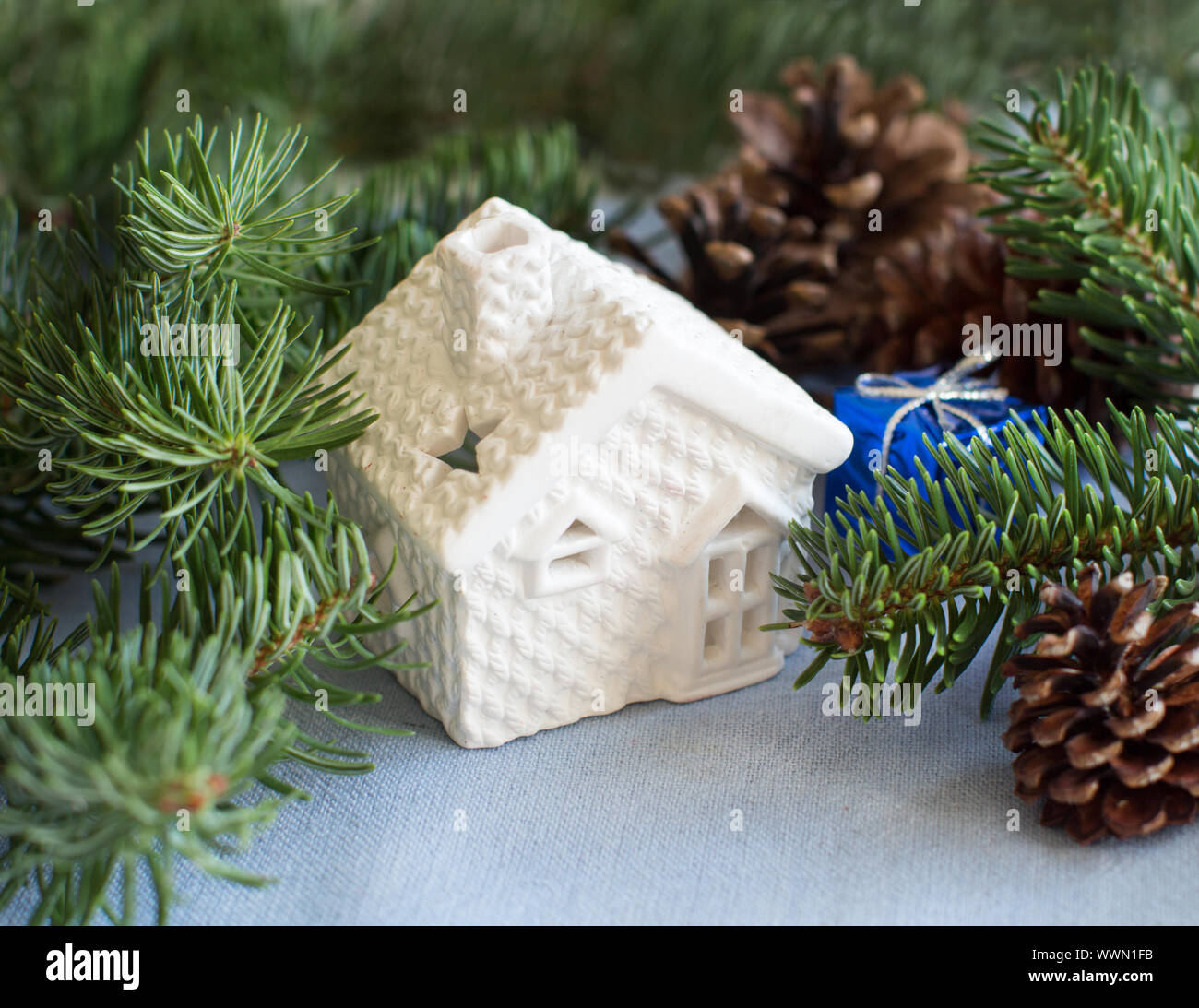 Christmas composition with tree branch, toy house and decorations Stock ...