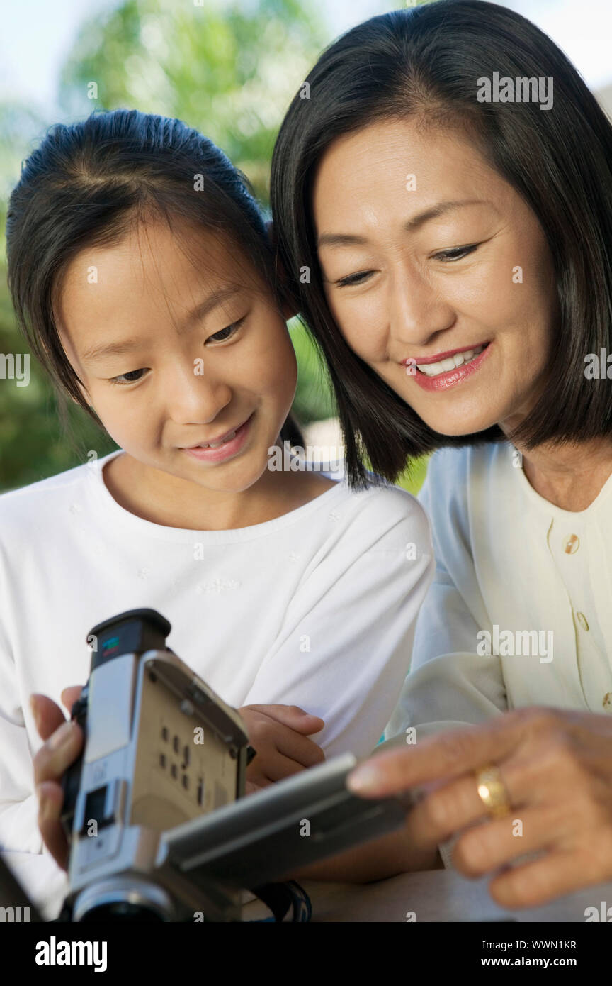 Mother and Daughter Looking at Video Camera Screen Stock Photo - Alamy