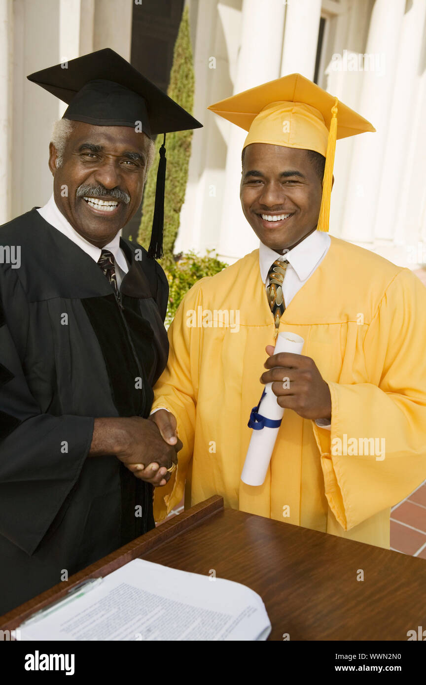 Graduate Shaking Hands and Receiving Diploma Stock Photo - Alamy