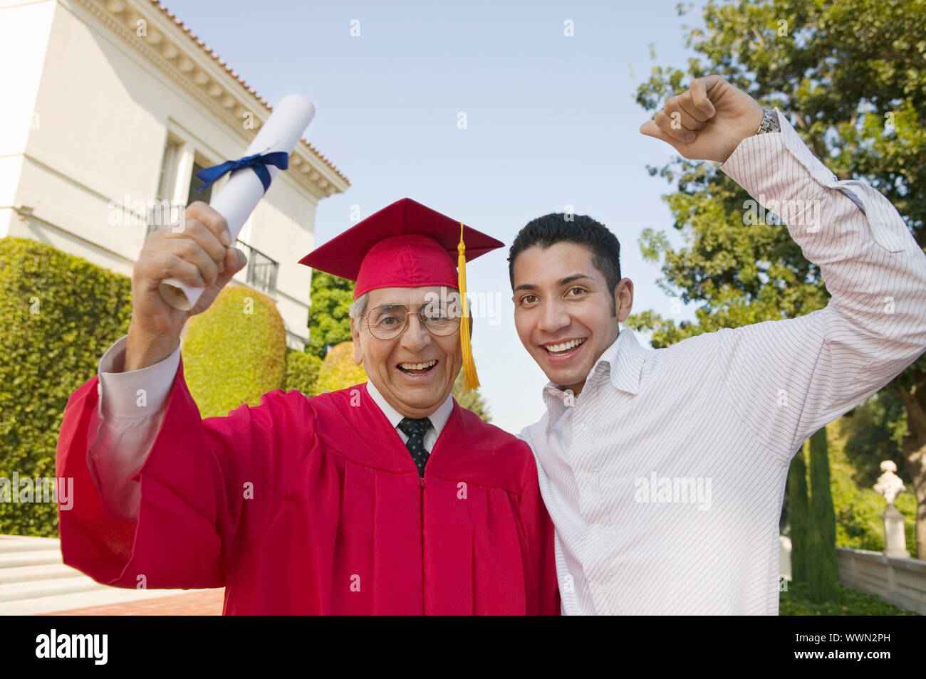 Excited Graduate with Son Stock Photo - Alamy
