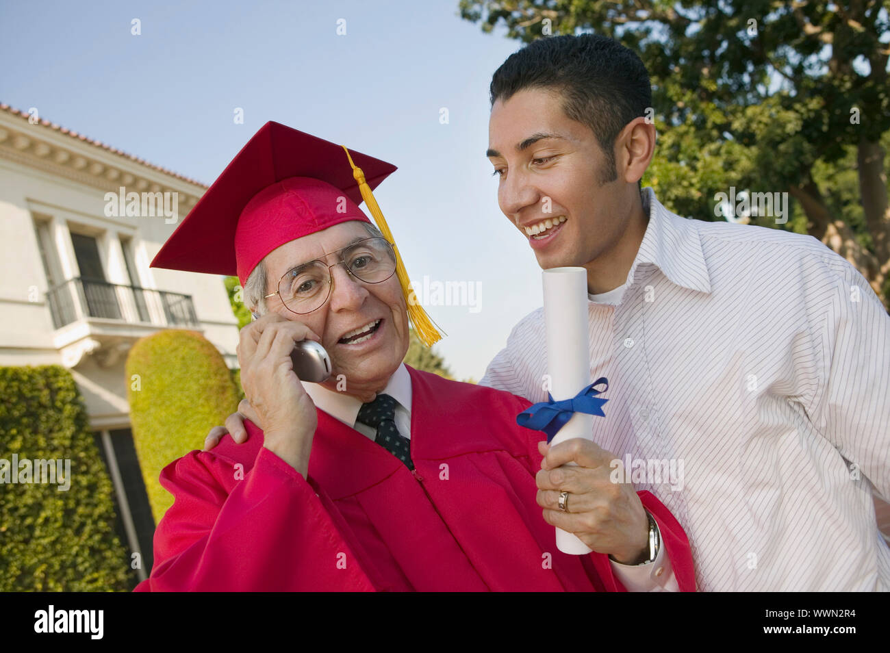 Excited Graduate with Son Stock Photo - Alamy