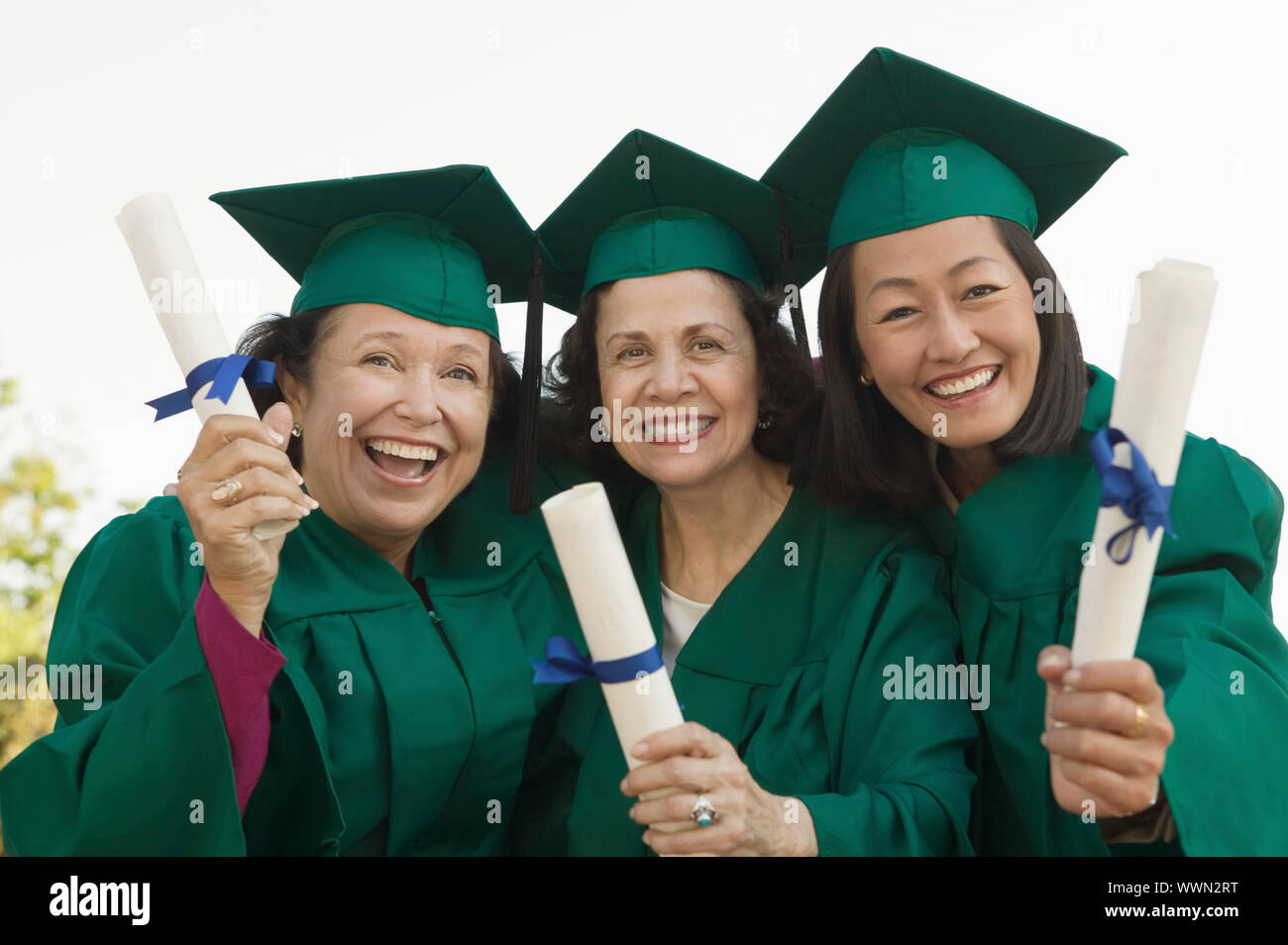 Smiling Graduates Holding Their Degrees Stock Photo - Alamy