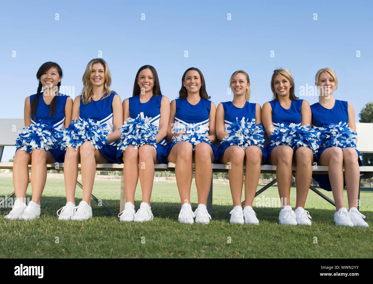 Cheerleading Squad Sitting on Bench Stock Photo - Alamy