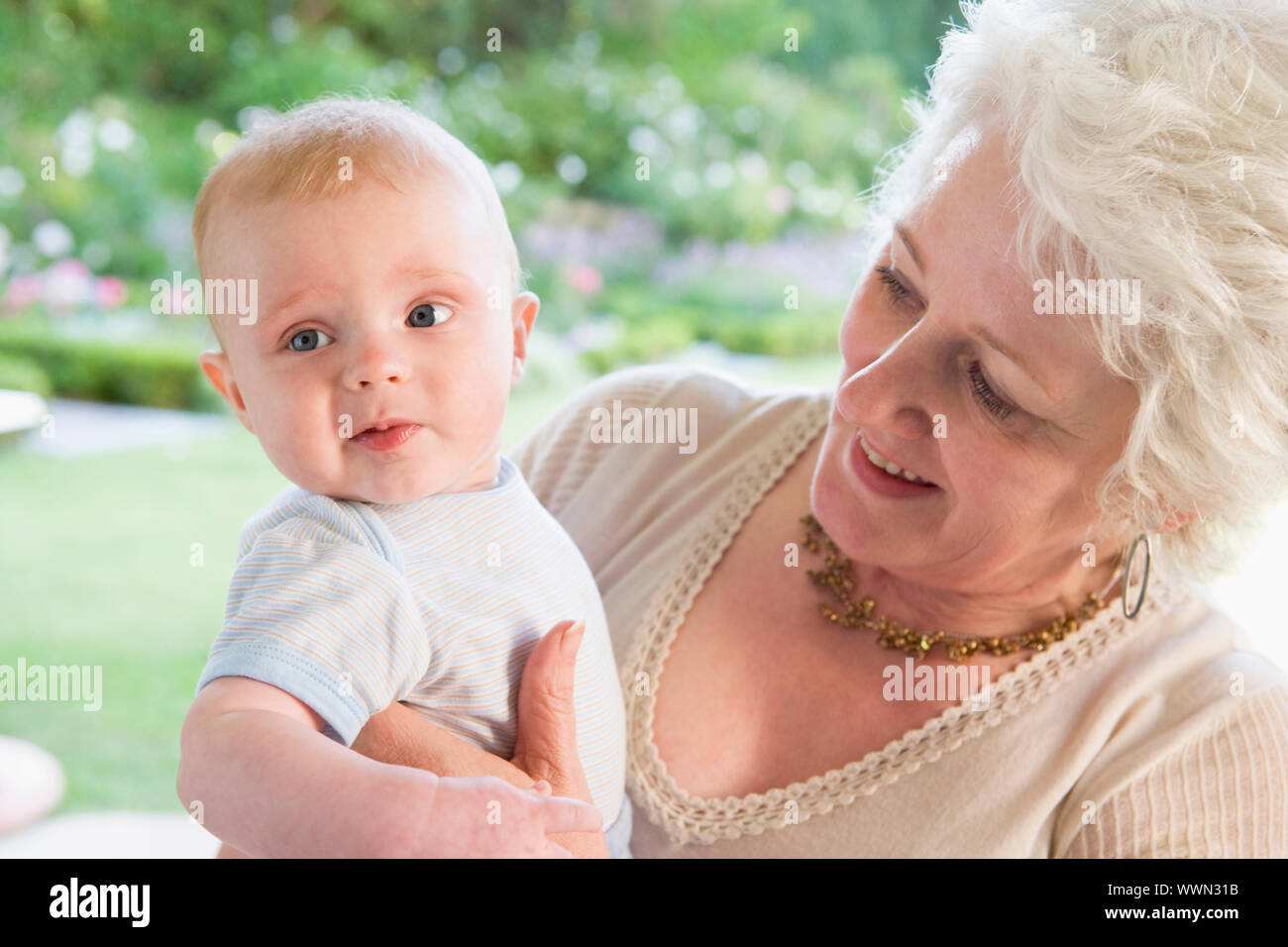 Grandmother cuddling baby boy hi-res stock photography and images - Alamy