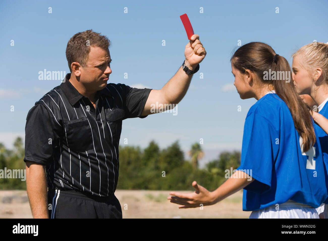 Soccer Referee Ejecting Player with Red Card Stock Photo - Alamy