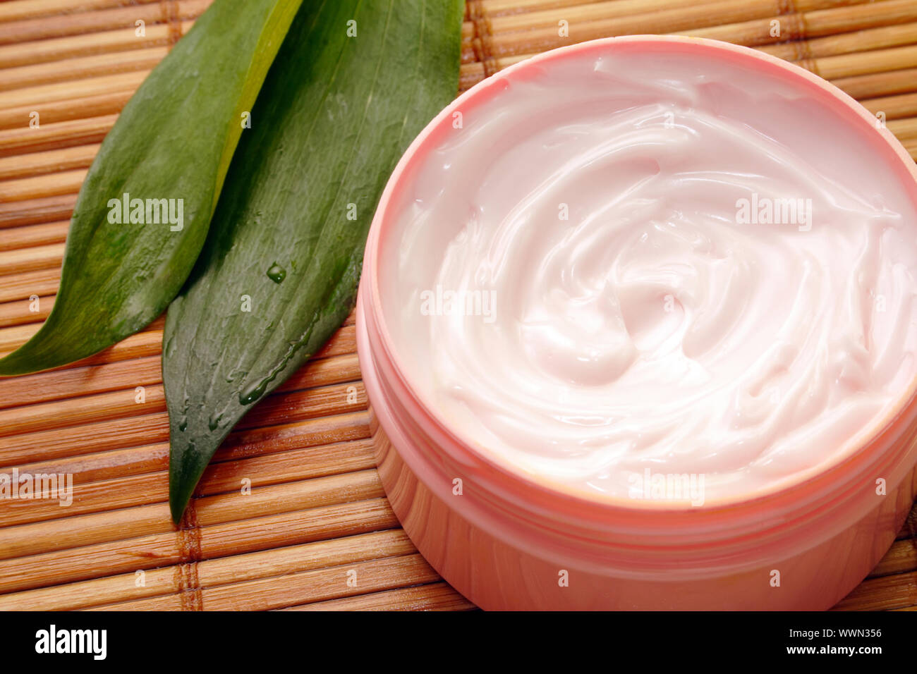 cosmetic cream against a background of bamboo Stock Photo - Alamy