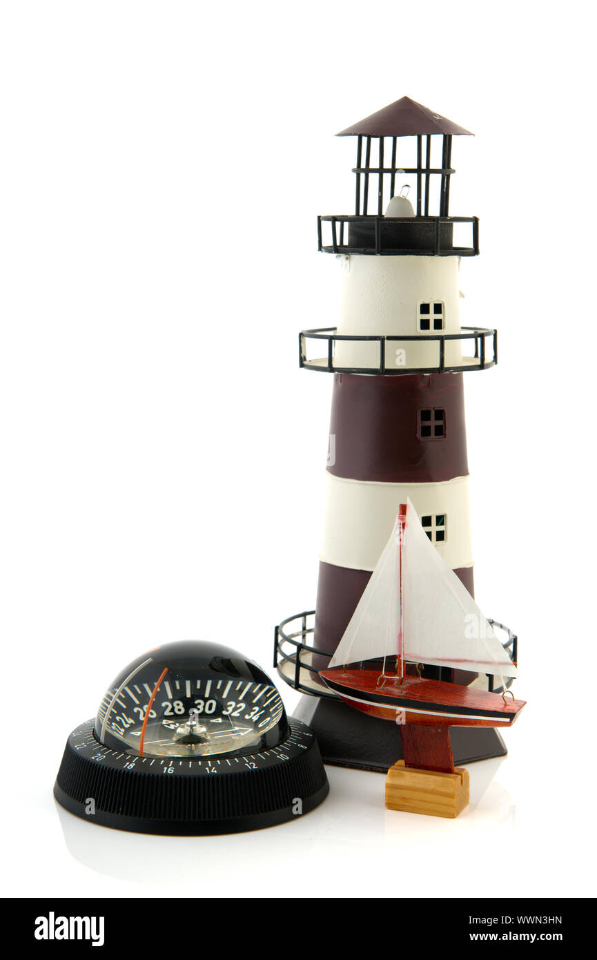 Nautical ship compassand lighthouse in still life Stock Photo - Alamy