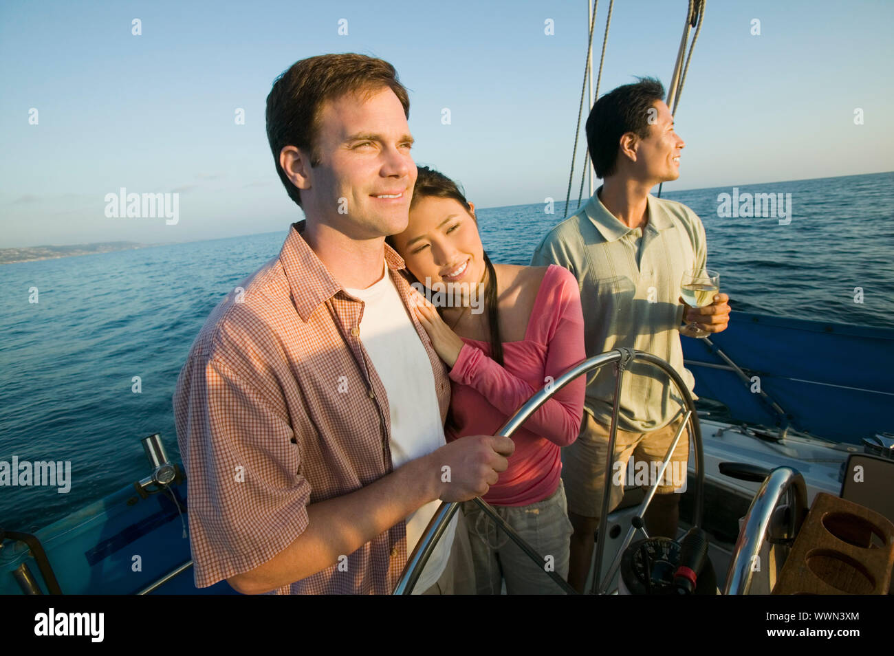 Couple with Friend on Boat Stock Photo - Alamy