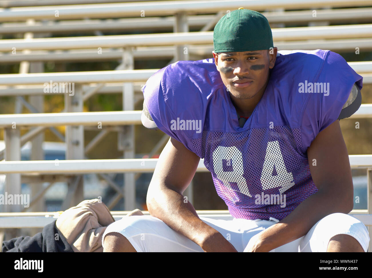 Football Player Watching from Bleachers Stock Photo - Alamy