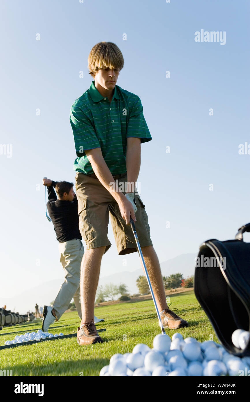 Young Men at Driving Range Stock Photo - Alamy