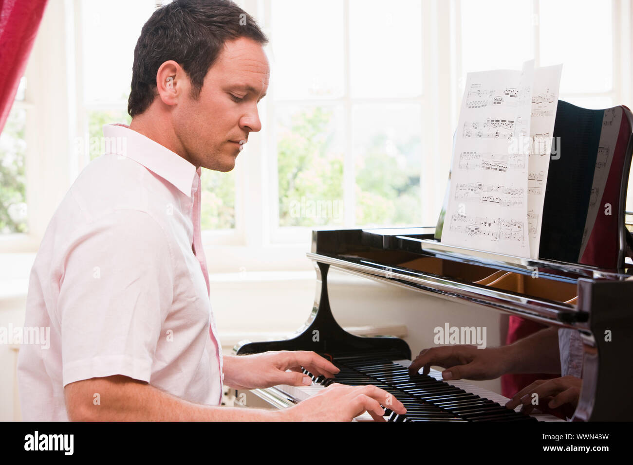 Man playing grand piano hi-res stock photography and images - Alamy