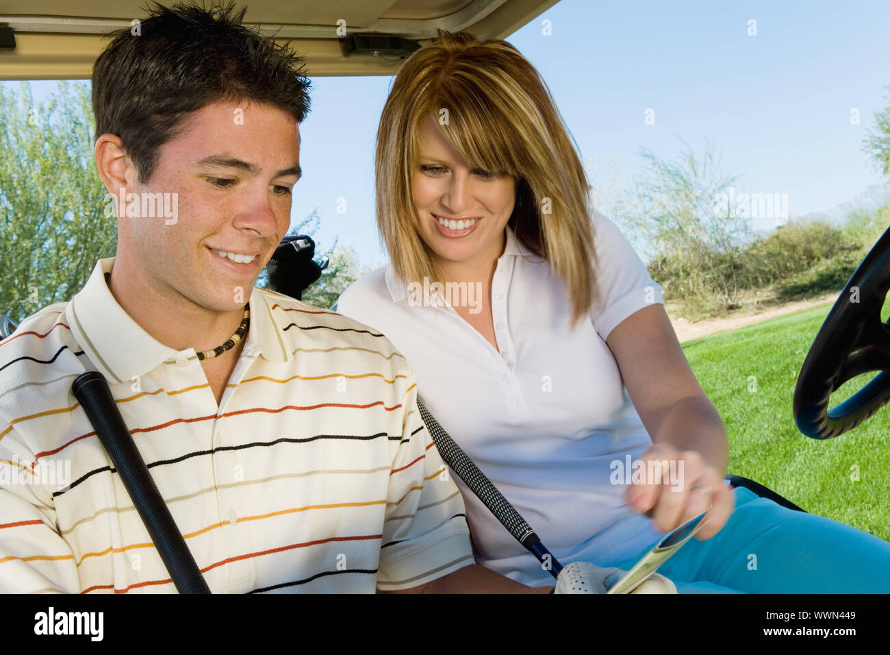 Golfers Looking at Score Card Stock Photo - Alamy