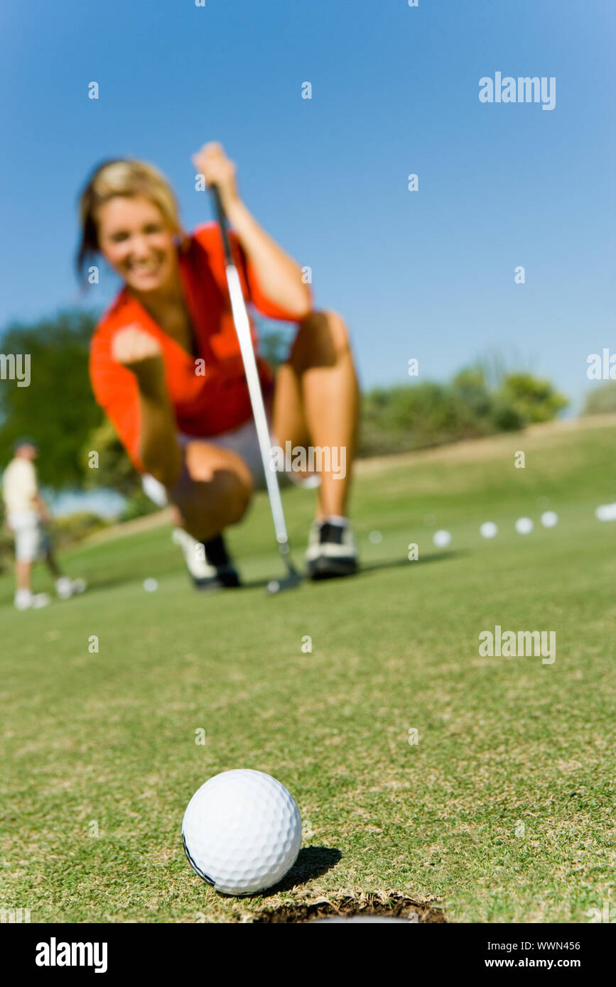 Golfer Watching Putt Sink Stock Photo - Alamy