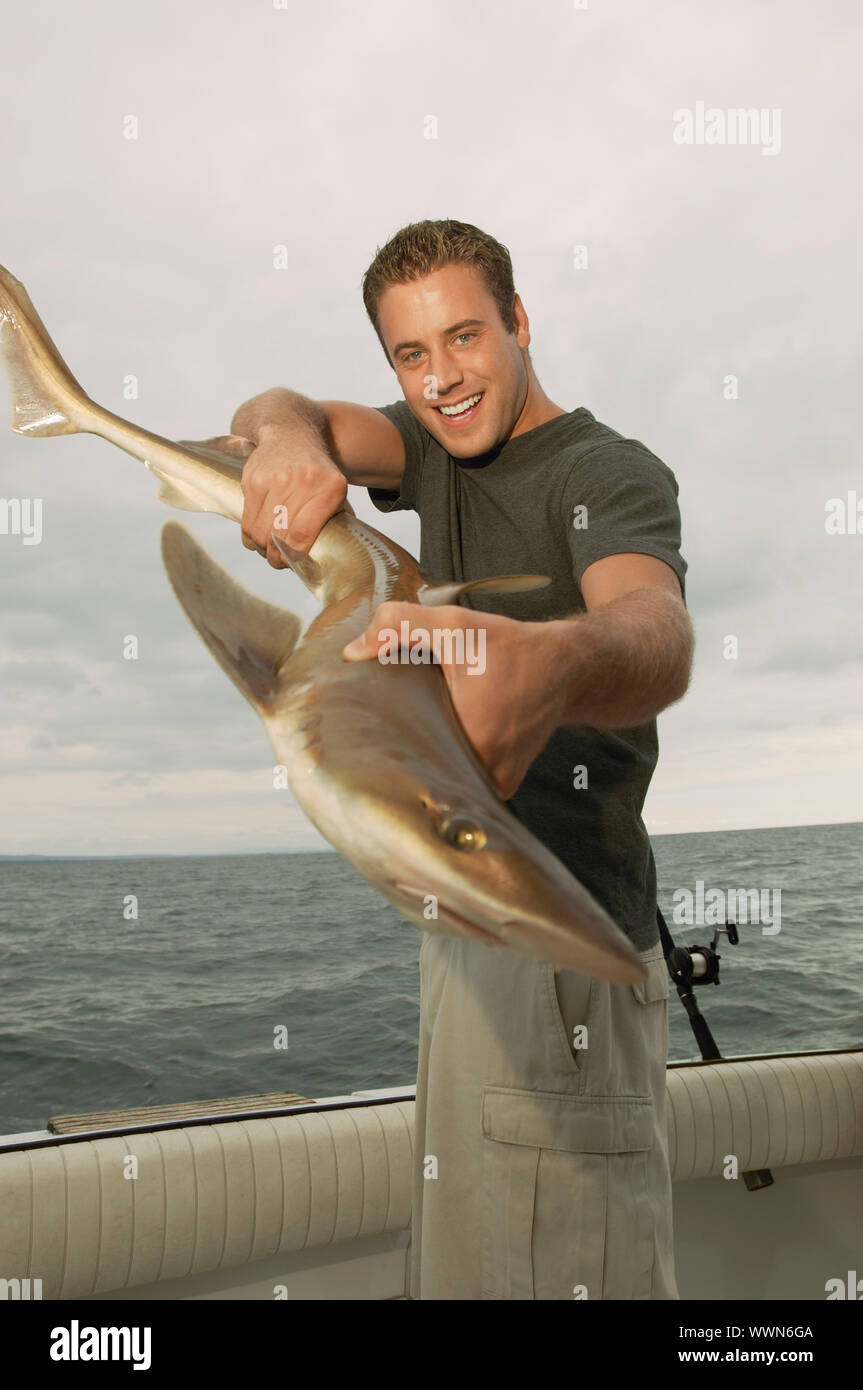 Sport Fisherman Displaying Shark Stock Photo - Alamy