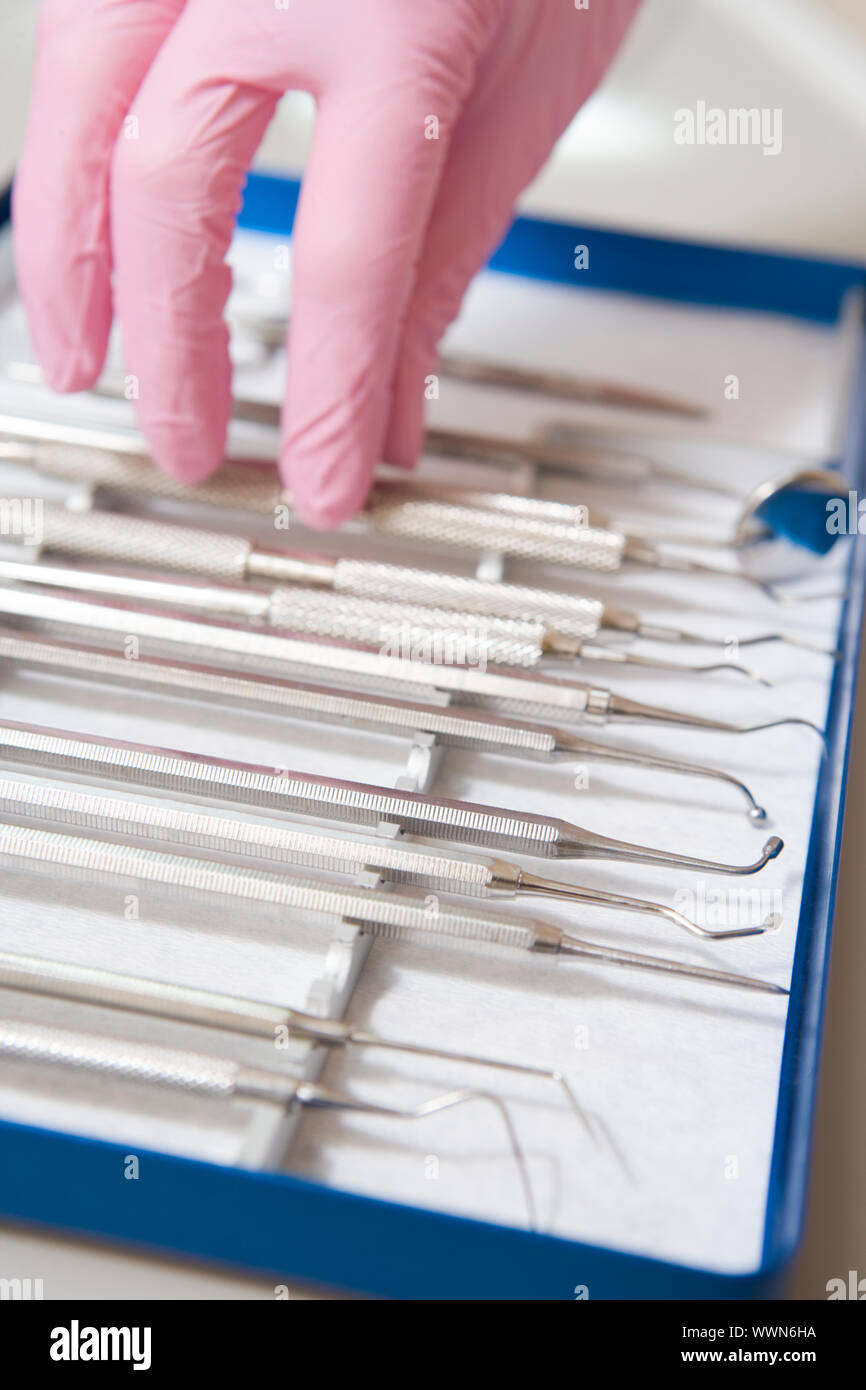 Dental tools with a gloved hand Stock Photo - Alamy