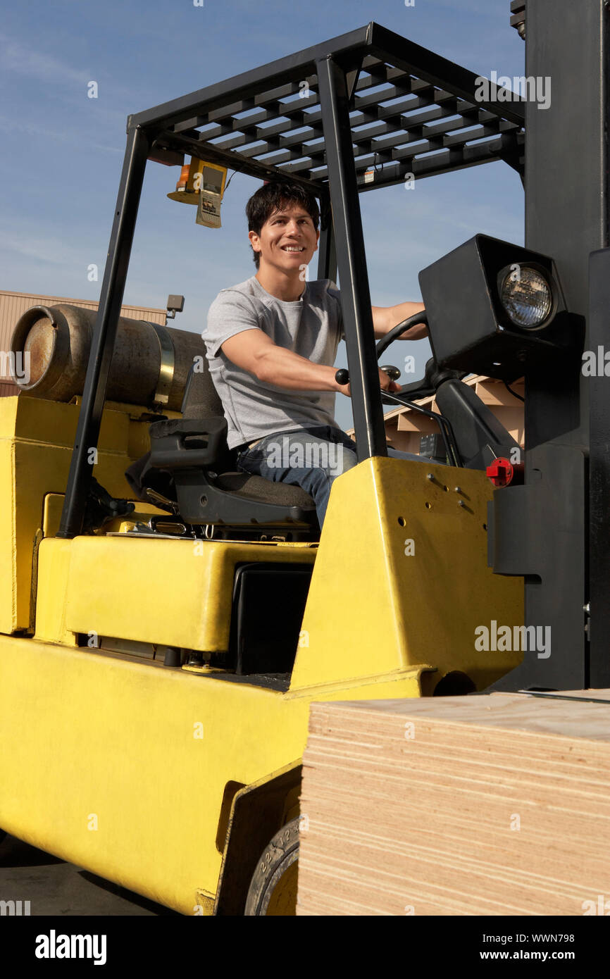 Forklift Driver on Forklift with Stack of Lumber Stock Photo - Alamy