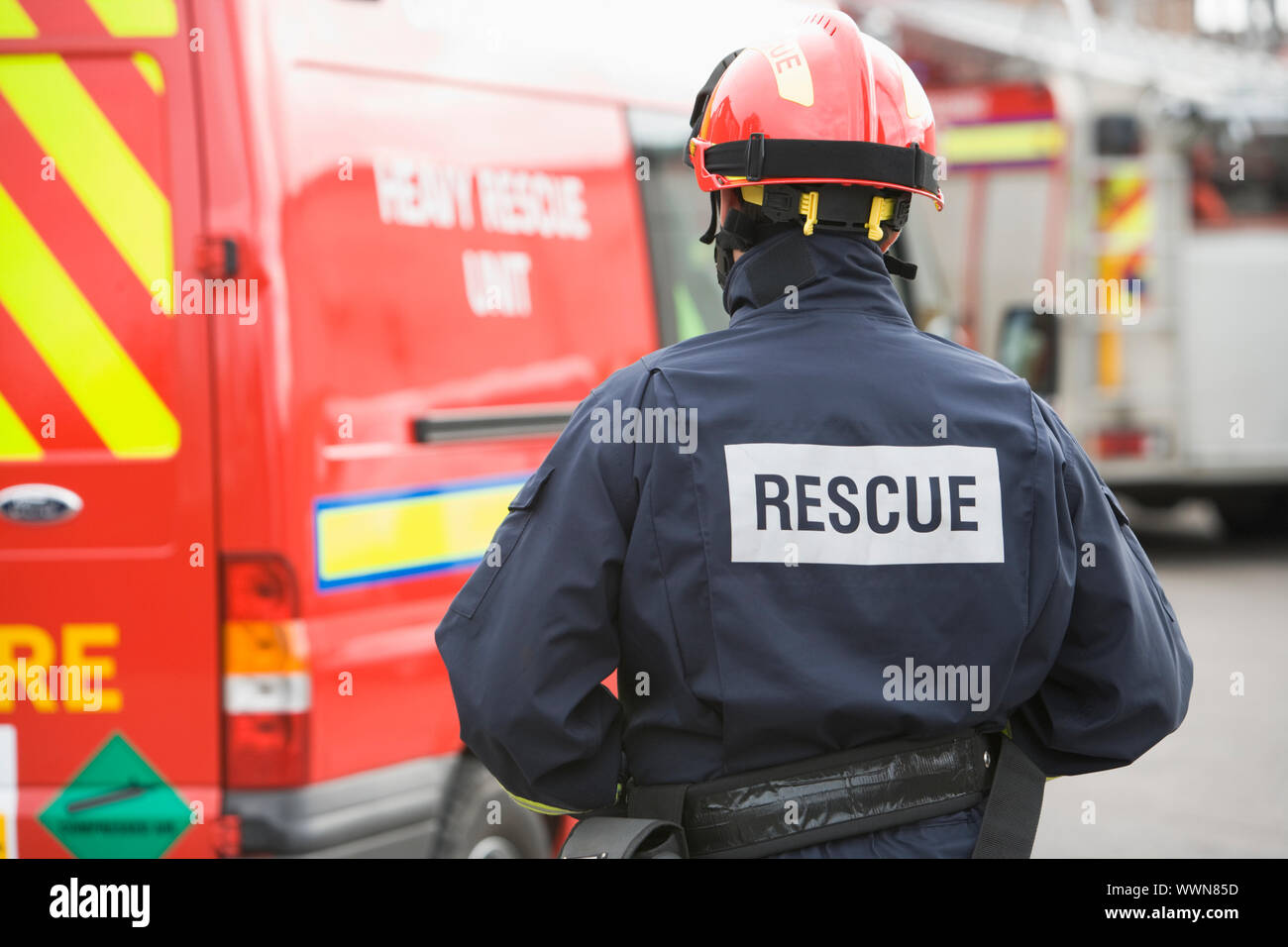 A firefighter standing by a small fire engine Stock Photo - Alamy