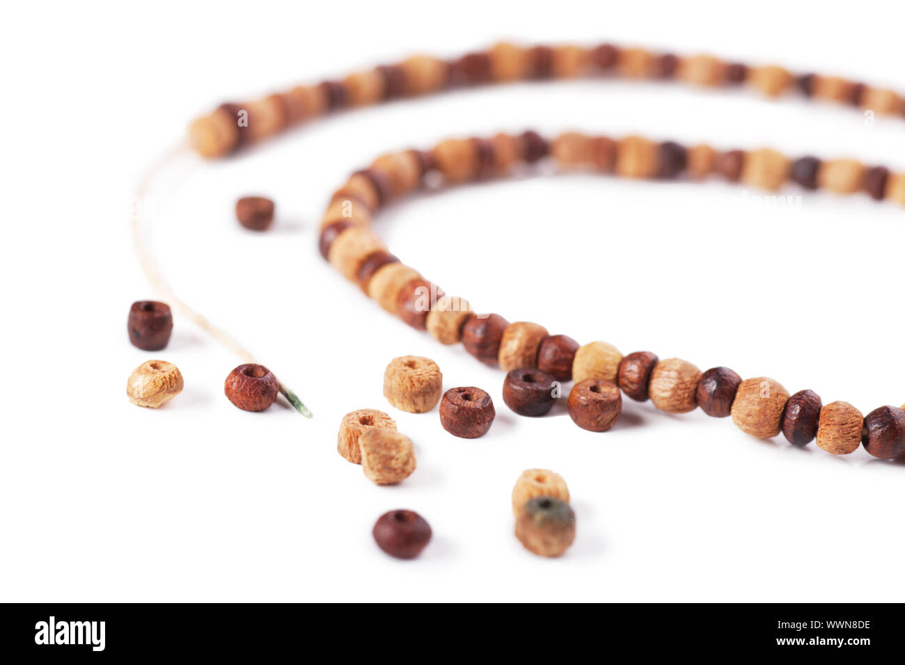 The torn necklace from wooden beads on a white background Stock Photo ...